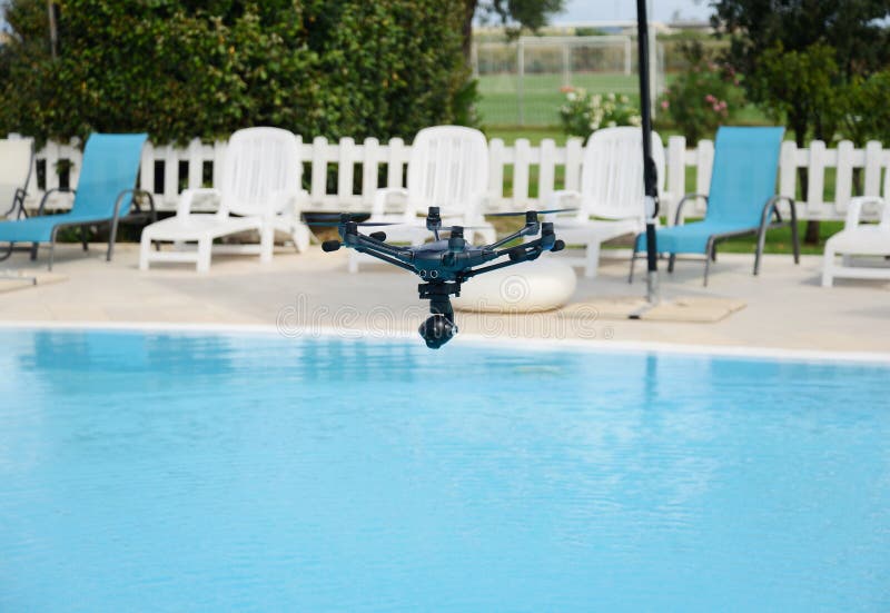 Drone Hovering Over Swimming Pool Stock Photo - Image of propeller ...