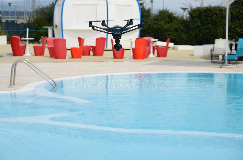 Drone Hovering Over Swimming Pool Stock Photo - Image of propeller ...