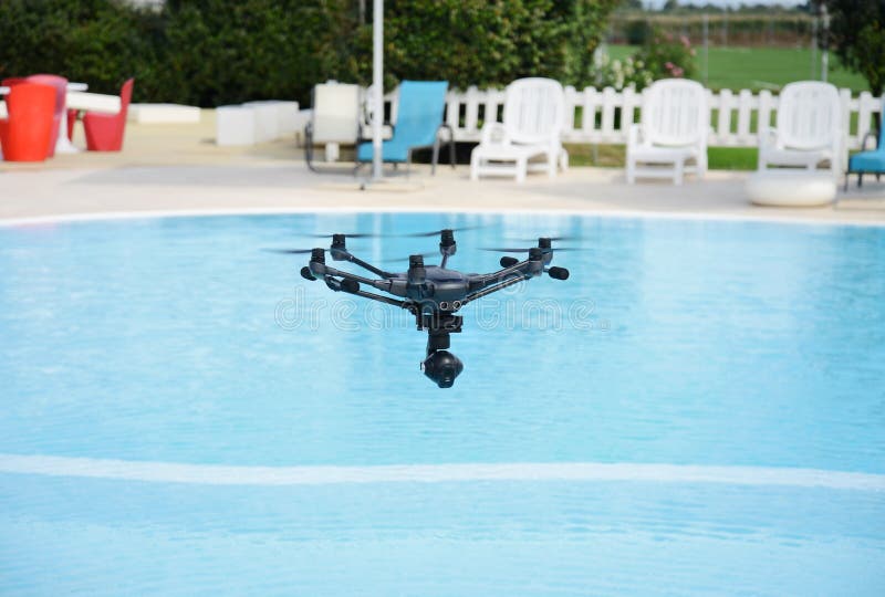 Drone Hovering Over Swimming Pool Stock Photo - Image of propeller ...