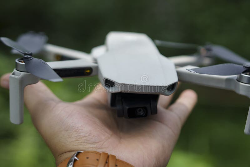 Drone Launch. Man Holds a Drone in His Hand Lifting it Up Stock Image ...