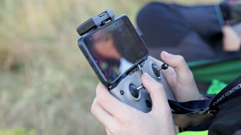 Drone Operator Hands Using Remote Control with Sticks and Cellphone As ...