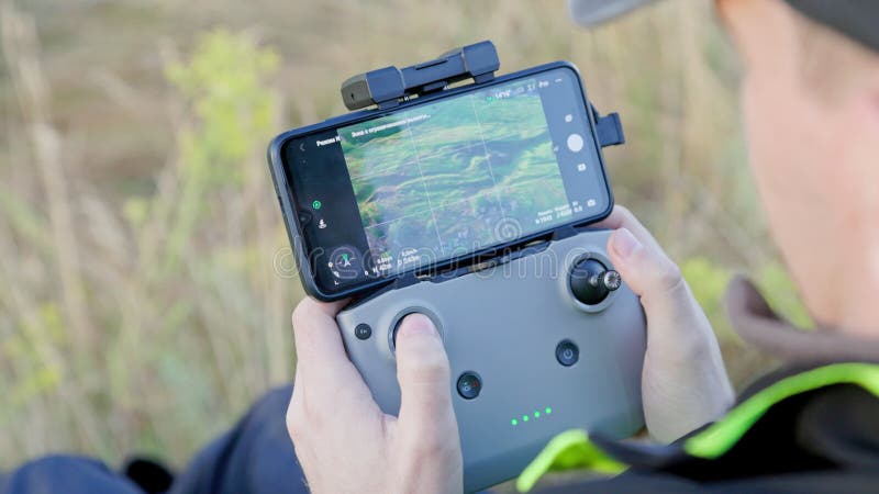 Drone Operator Hands Using Remote Control with Sticks and Cellphone As ...