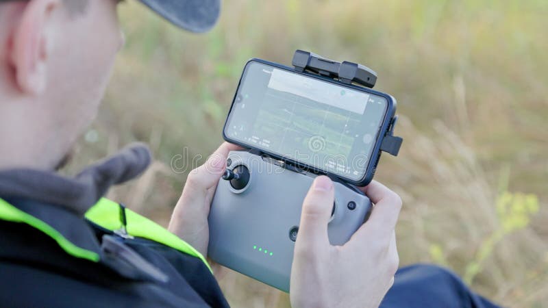 Drone Operator Hands Using Remote Control with Sticks and Cellphone As ...