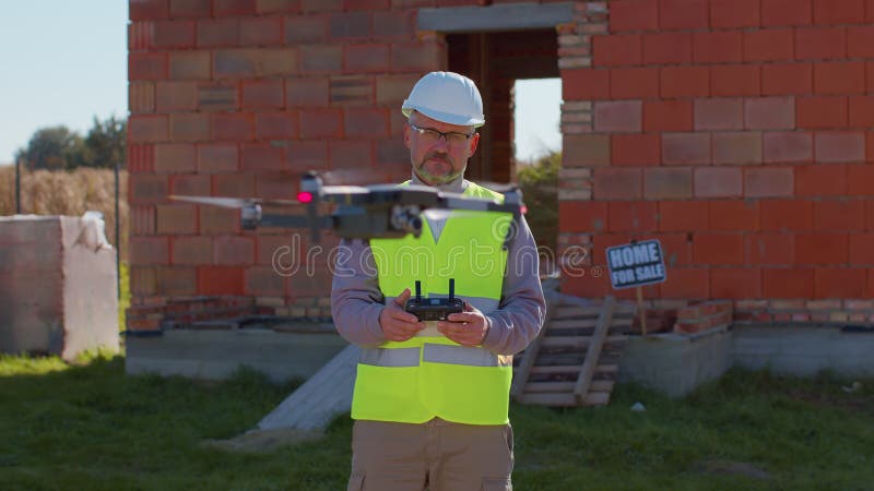 Drone Operator Holding Remote Controller Controls an Aircraft in Front ...