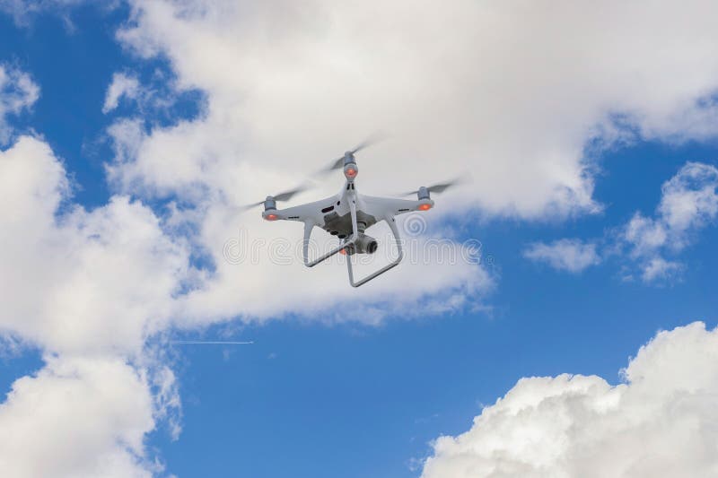 Drone Quadcopter with Digital Camera Flying in Front of Cloudy Sky ...