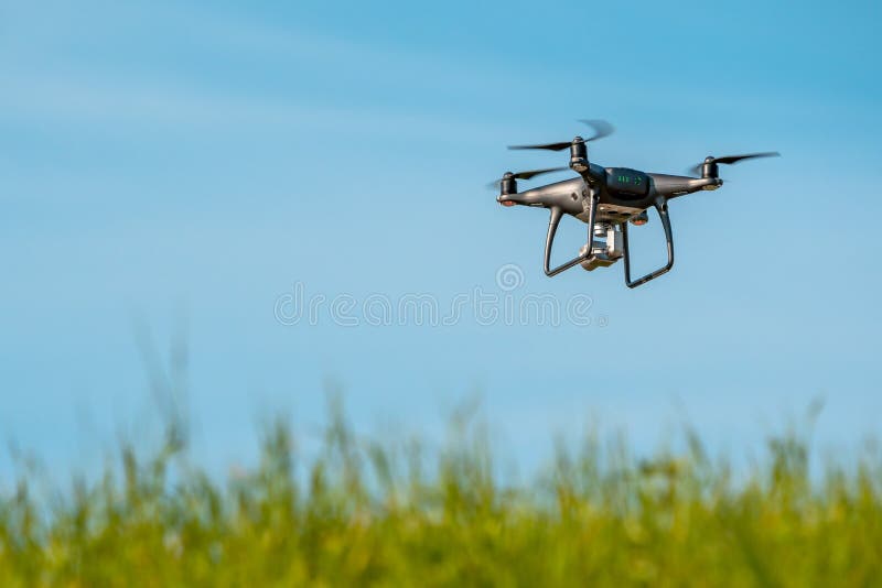 Drone Quadcopter Hovering Over Grass Field Stock Photo - Image of video ...