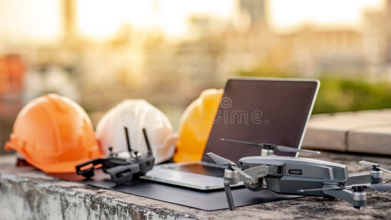 Drone, Remote Control, Laptop and Helmet at Construction Site Stock ...