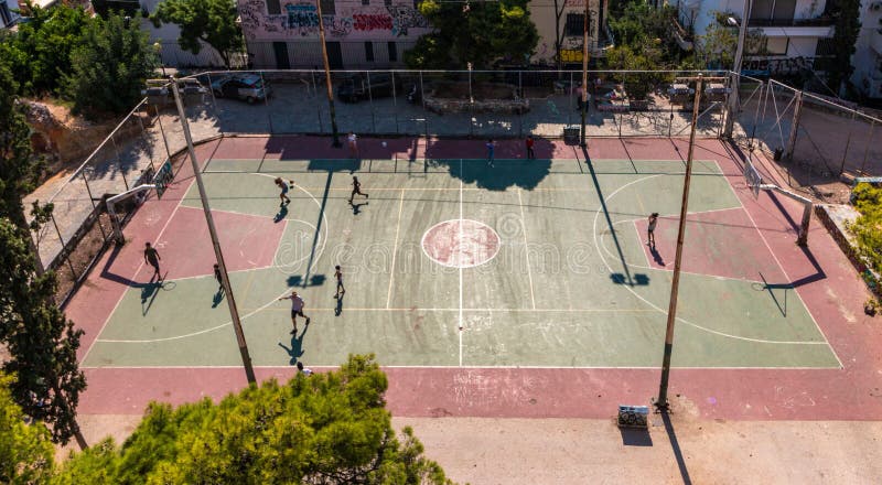 Drone Shot of a Basketball Field with a Group of People Playing There ...