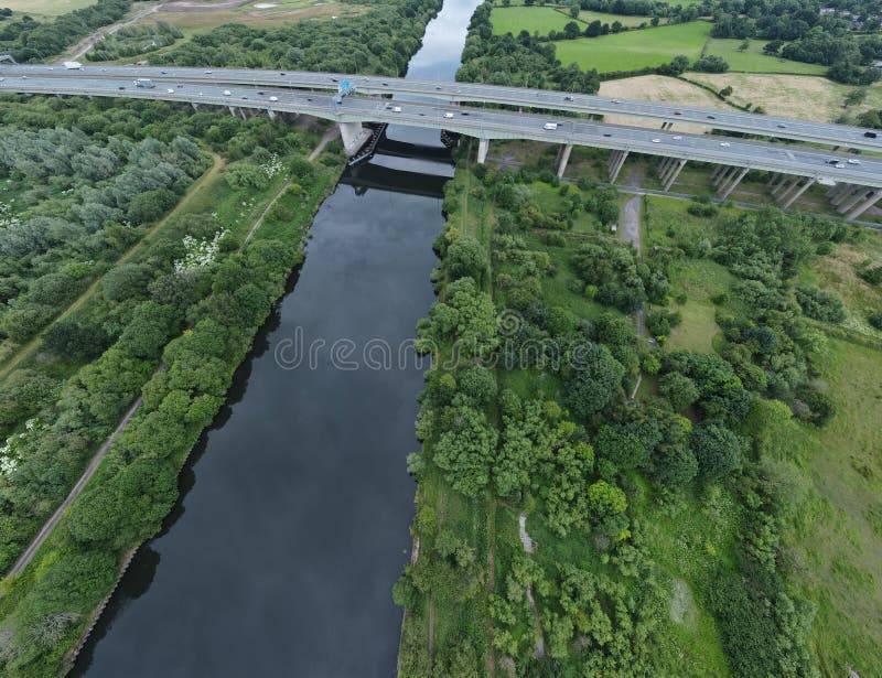 Drone Shot of a Bridge Over a River Passing between Tree Covered Land ...