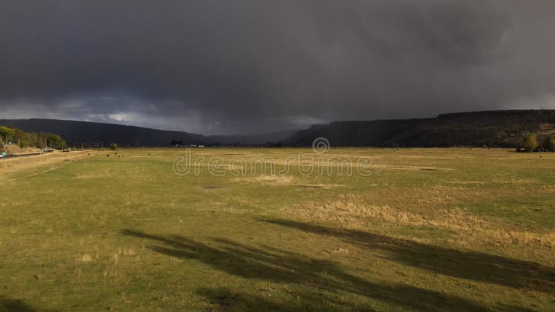 Drone Shot of a Cloudy Dark Sky on a Green Field Stock Footage - Video ...