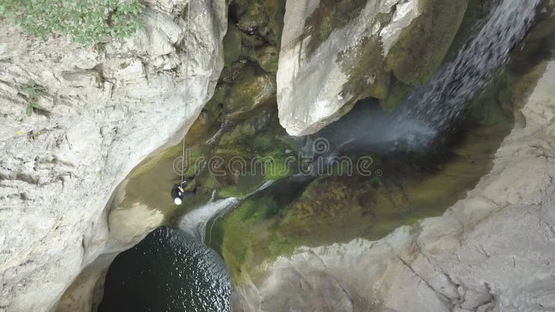 Drone Shot of a Man Rappelling Down a Waterfall in a Canyon Stock Video ...