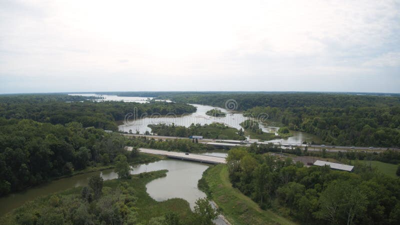Drone Shot of a Scenic River Flowing through a Densely Vegetated Green ...