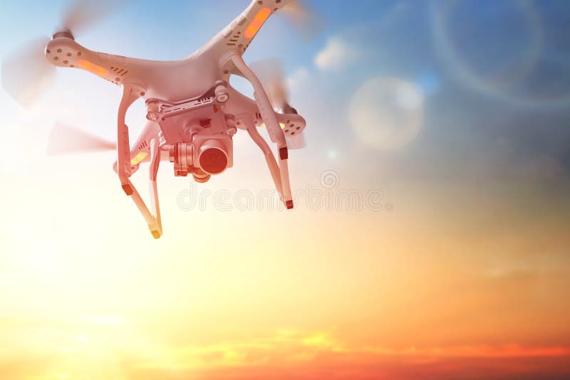 Drone in the sunset sky stock photo. Image of camera - 85084222