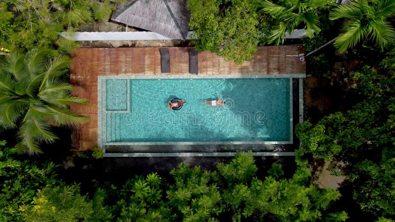 Drone View from Above at Couple in Swimming Pool in the Rainforest ...