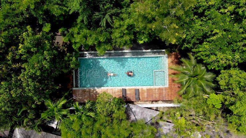 Drone View from Above at Couple in Swimming Pool in the Rainforest ...