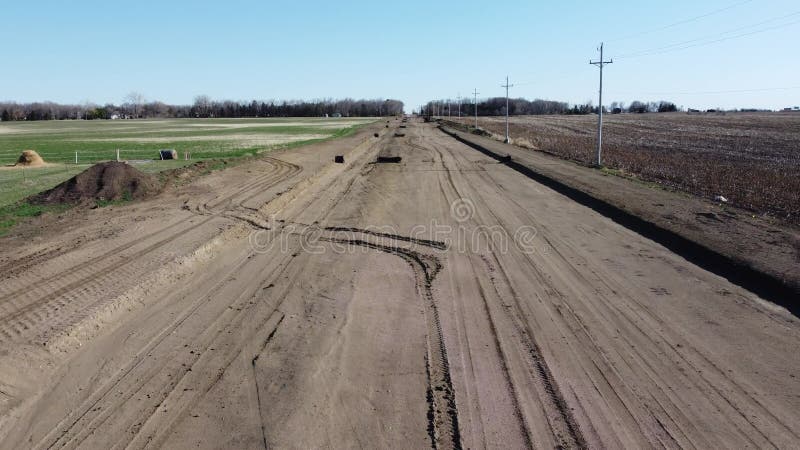 Drone View Flying Down a Road Construction Project with Compacted Dirt ...