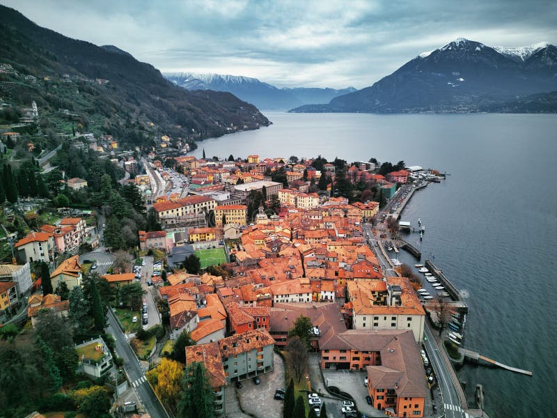 Drone View of Lake Como Surrounded by a Town and Mountains in the ...