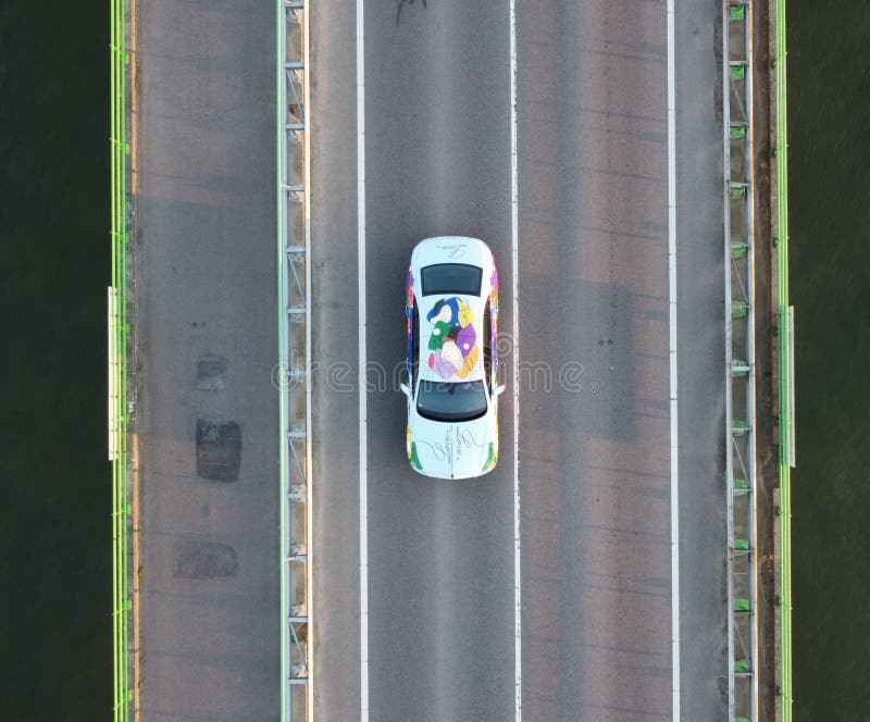 Drone View of a Painted White Bentley Unifying Spur Car Driving on a ...
