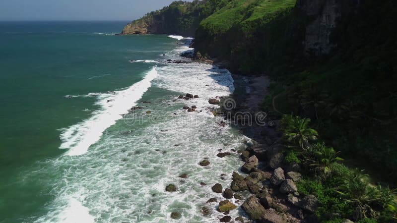 Drone View of the Seaside with Cliffs, Lush Hills and Waves from the ...