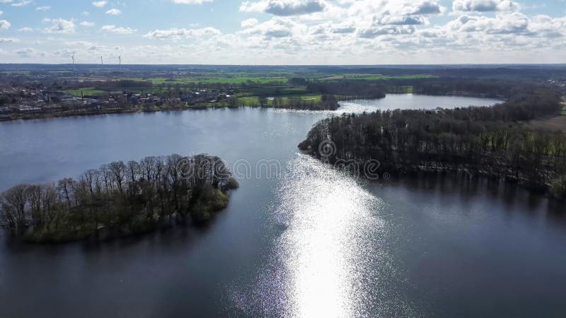 Drone View of a Small Lake in Low Sun Surrounded by Fields and Woods ...