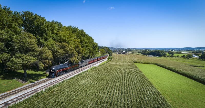 Drone View of a Steam Passenger Train Approaching a Track Switch with ...