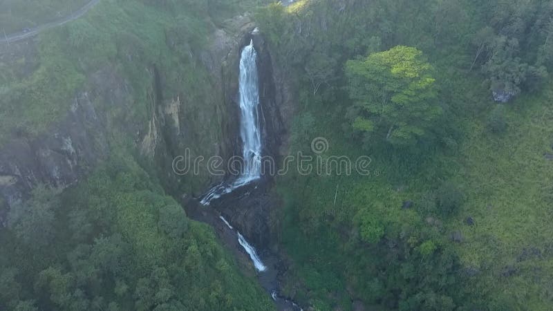 Drone View of a Waterfall Streaming in the Middle of Greenery from ...