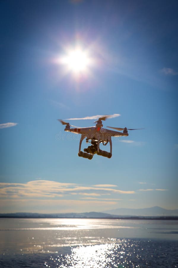 Drone watching the sunset stock photo. Image of propeller - 49776944