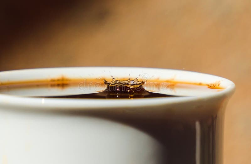 A Drop of Coffee Falls into a White Porcelain Mug Full of Freshly ...