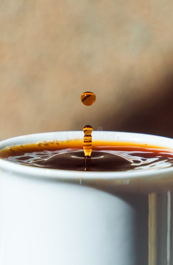 A Drop of Coffee Falls into a White Porcelain Mug Full of Freshly ...