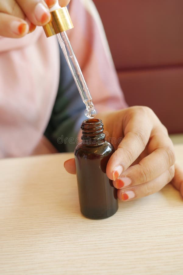 Women Hand Drop Falls from a Pipette into a Cosmetic Bottle Stock Image ...