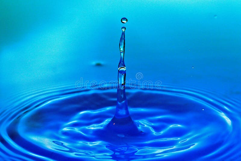 A Drop Falls into the Water, Forming Floating Balls and a Splash Crown ...