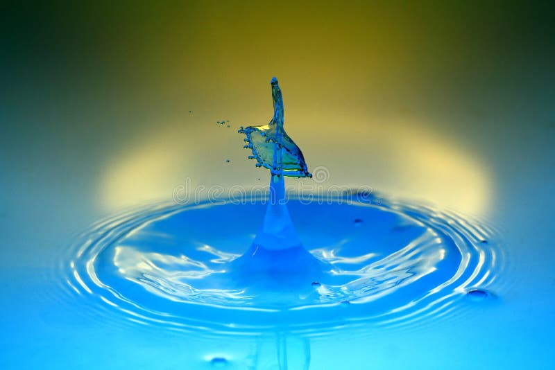 A Drop Falls into the Water, Forming Floating Balls and a Splash Crown ...