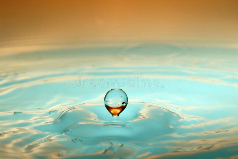 A Drop Falls into the Water, Forming a Floating Ball and Concentric ...