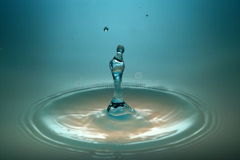 A Drop Falls into the Water, Forming Floating Balls and a Splash Crown ...