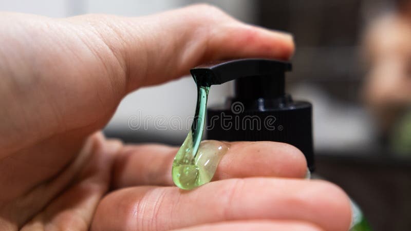 Drop of green liquid soap stock photo. Image of finger - 367610722