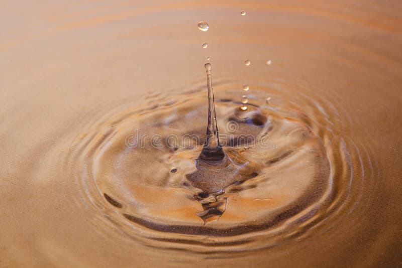 The Drop Hits the Surface of the Water, Leaving Behind Splashes and ...