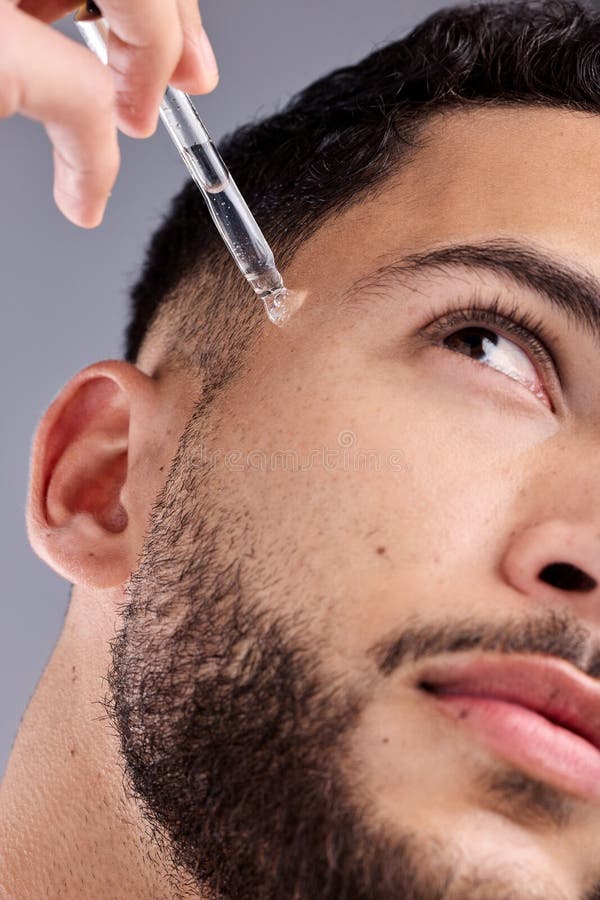 A Drop is Just about Enough. a Handsome Young Man Applying Serum To His ...
