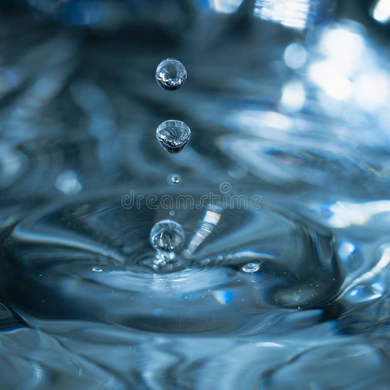 Drop of Liquid Falling into a Clear Glass Container Full of Water Stock ...