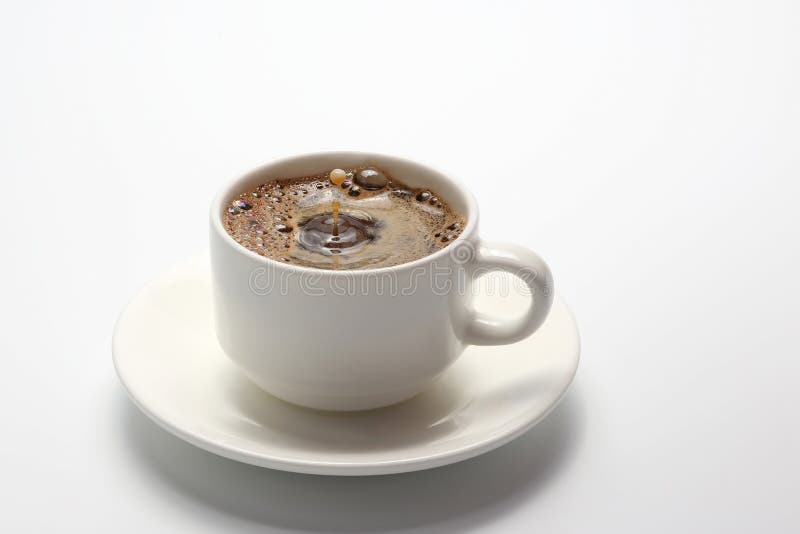 Drop of Milk Falling in a White Cup with Black Coffee Stock Photo ...