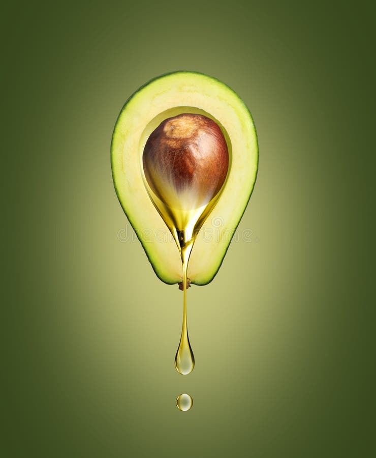 Drop of Oily Liquid Flowing from a Half of Avocado on a Green ...