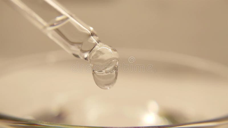 A Drop of Perfume Liquid Drips from the Pipette into the Water Stock ...