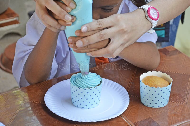 Drop Sweet Cream on Cupcake Stock Photo - Image of baked, hand: 62575094