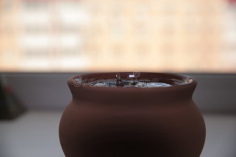 A Drop of Water in a Clay Pot Stock Image - Image of form, abstraction ...