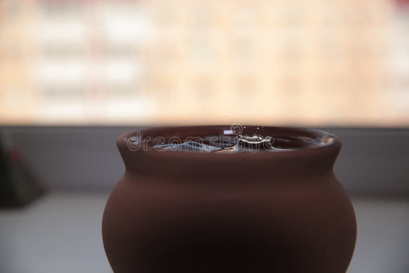 A Drop of Water in a Clay Pot Stock Image - Image of rain, abstraction ...
