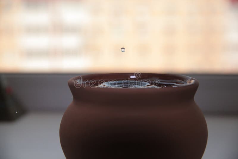 A Drop of Water in a Clay Pot Stock Image - Image of surface, color ...