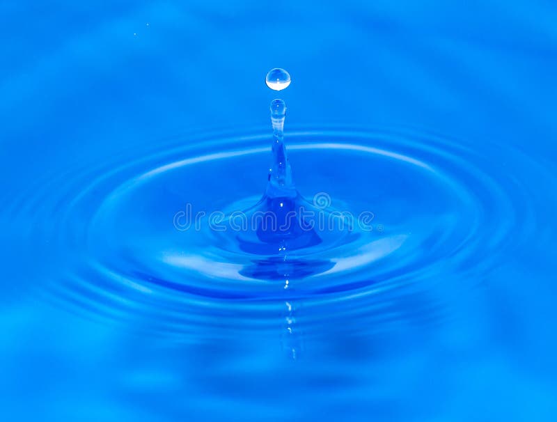 A Drop of Water Falling in Blue Water. Macro Stock Image - Image of ...