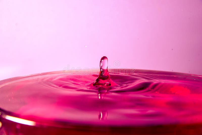 Drop of Water Falling in Red Water and Red Background. Stock Photo ...