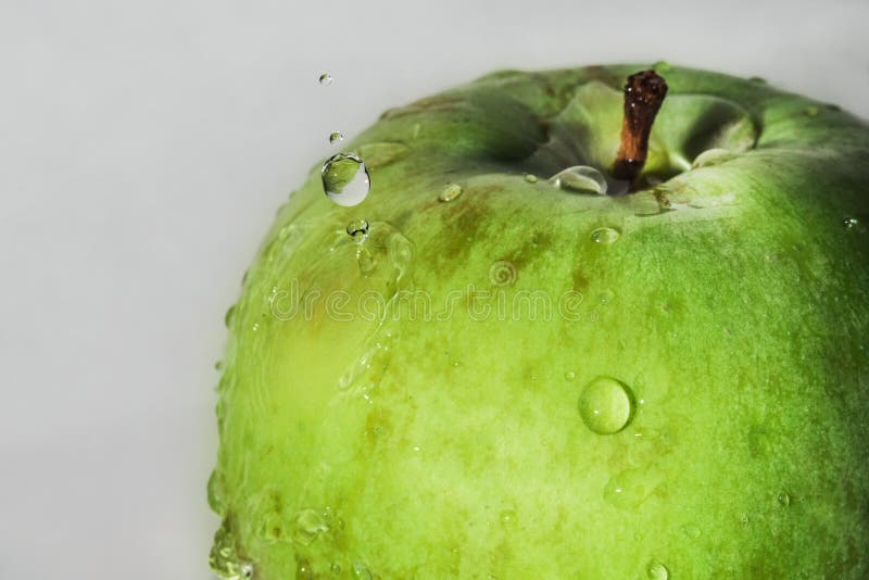 A Drop of Water Falls on a Ripe Green Apple Stock Image - Image of ...