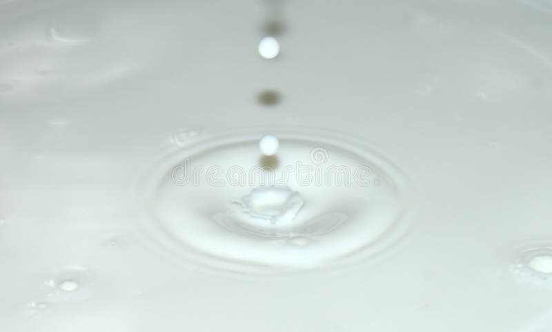 Drop of White Fresh Milk Falling To Surface Splashing and Making Wave ...