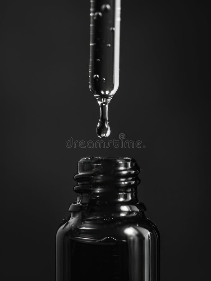 Droplet of Liquid is Falling from a Bottle Stock Image - Image of ...